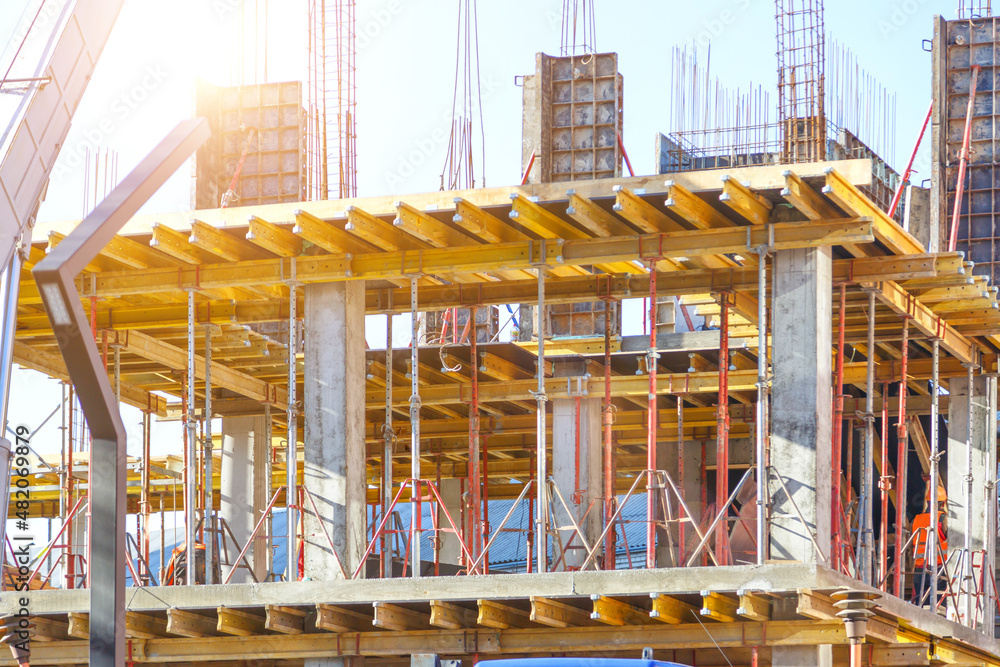 Building construction site work against blue sky.Hydraulic luffing jib ...