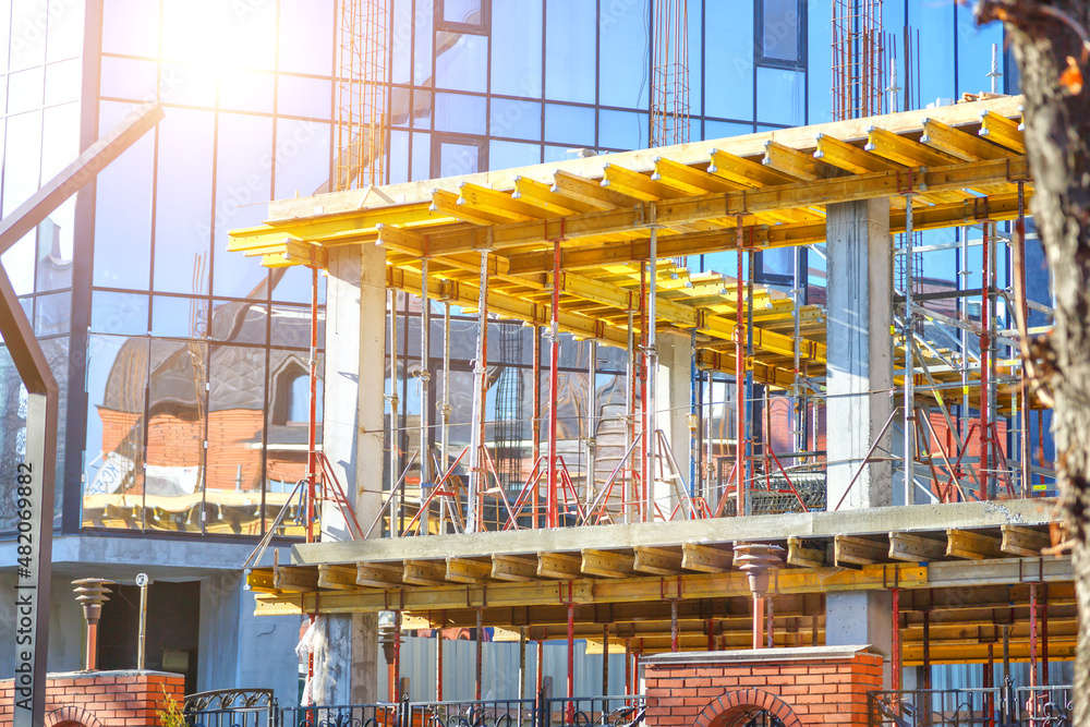 Building construction site work against blue sky.Hydraulic luffing jib ...