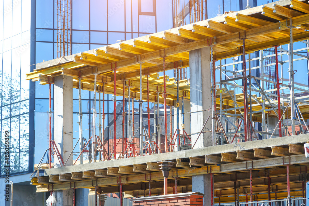 Building construction site work against blue sky.Hydraulic luffing jib ...