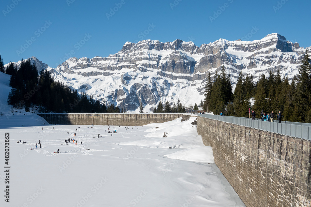 Eisfischer auf dem gefrohrenen Stausee Garichti Stock Photo | Adobe Stock