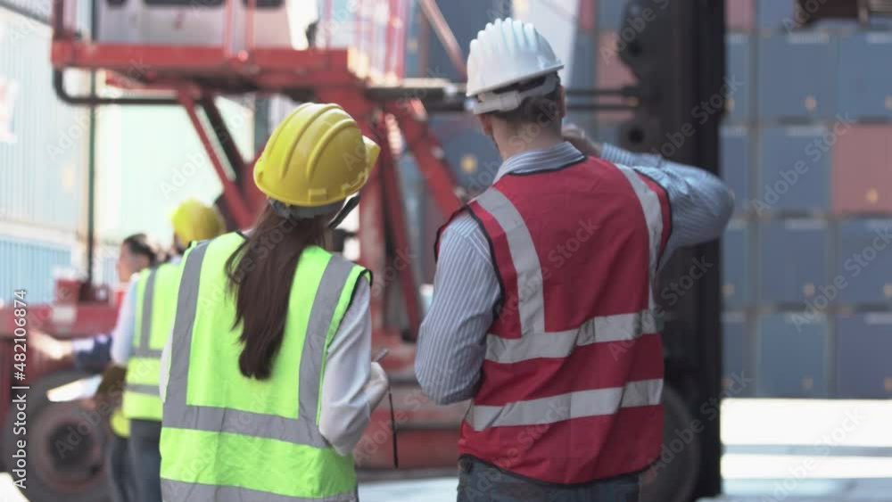 Engineer and foreman in hardhat and safety vest control loading ...