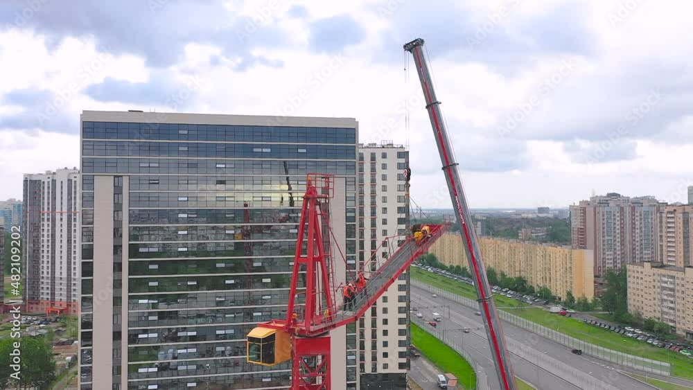 Installing the jib of a construction crane using another crane on the ...