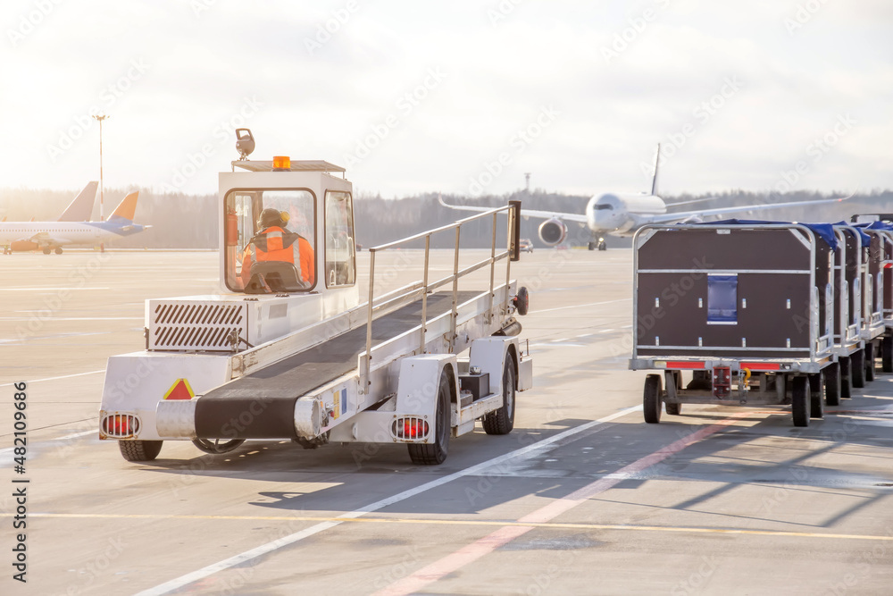 Baggage carts and a machine for loading luggage into the cargo hold of ...