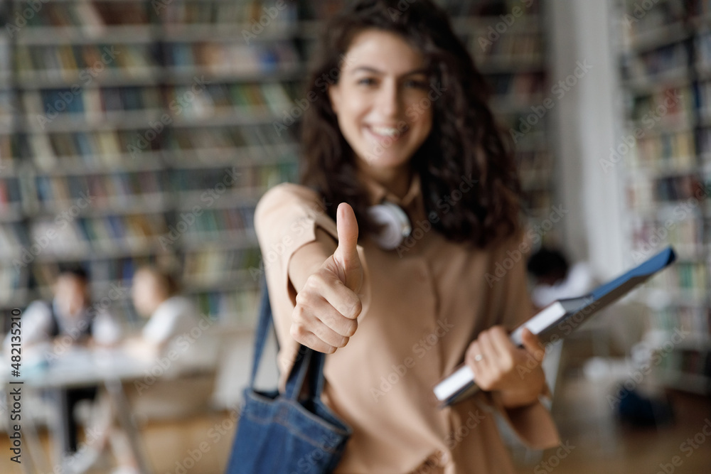 Happy satisfied college girl making thumb up, showing like hand sign at ...