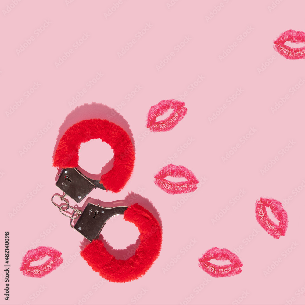 Valentines day creative pattern with red furry handcuffs and kiss ...