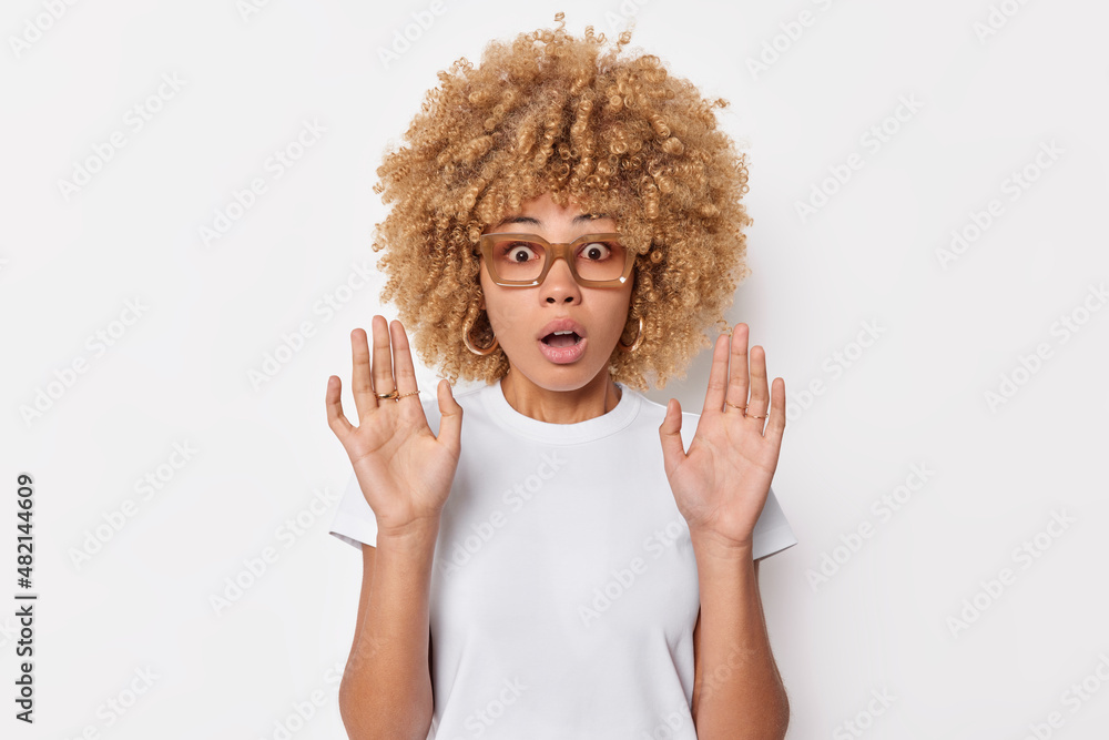 Shocked Speechless Curly Haired Woman Keeps Palms Raised In Defensive