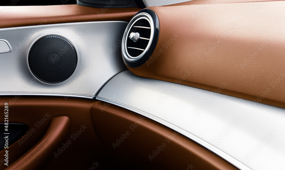 Car door handle inside the luxury modern car with brown leather texture ...