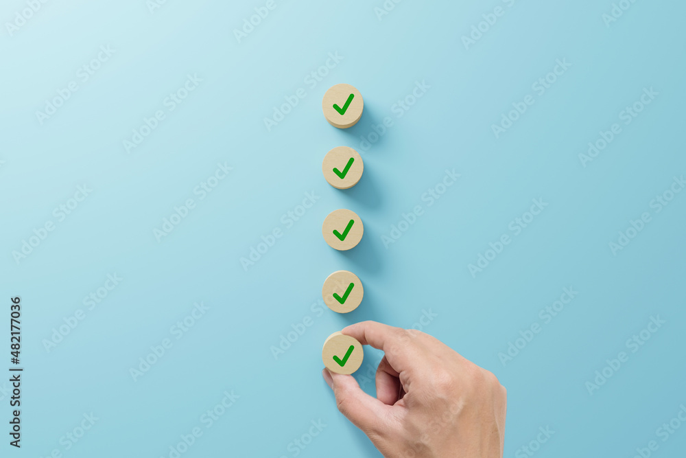 Checklist and check mark concept. Check mark on wooden blocks on light ...