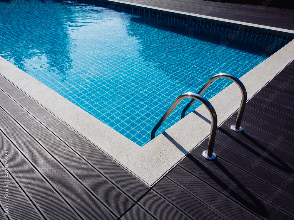 Stone edge frame on the square swimming pool with clean clear water ...