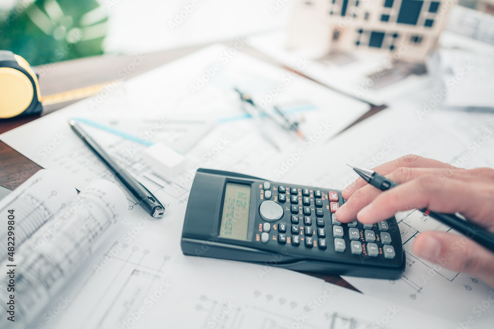 Architect engineer use calculator for calculate drawing design working ...