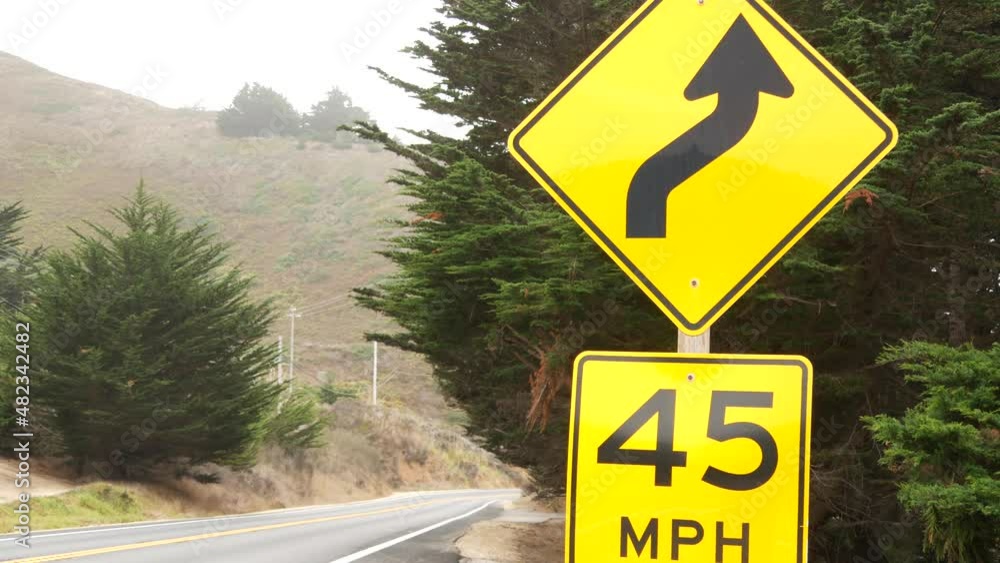 Speed limit sign, yellow warning or caution about curves, turns or ...