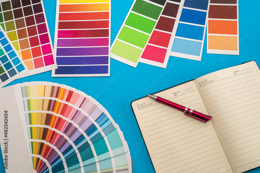 Architectural color floor plan with color swatches on desk Stock Photo ...