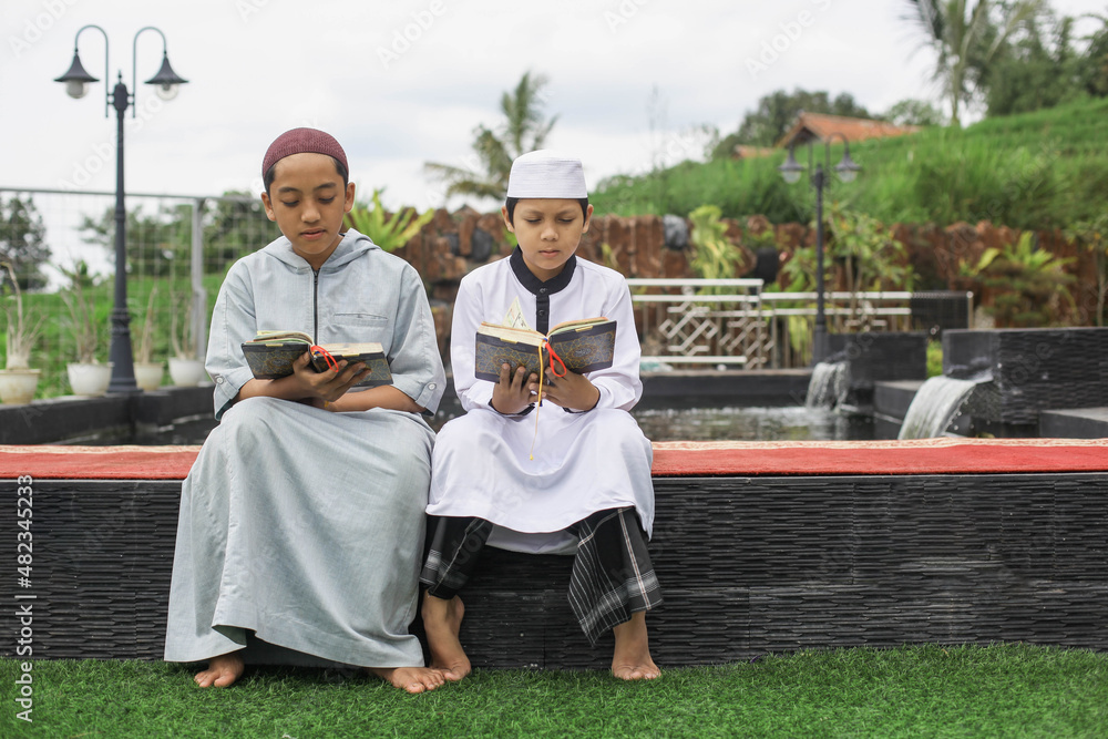 Islamic boarding school students memorize the Qur'an in the courtyard ...
