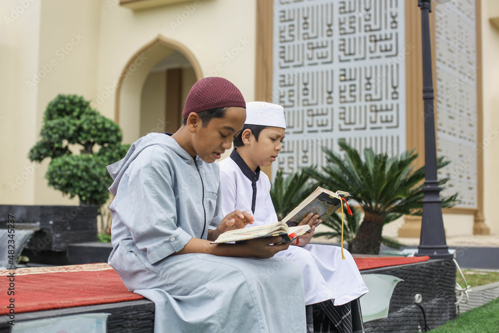 Islamic boarding school students memorize the Qur'an in the courtyard ...
