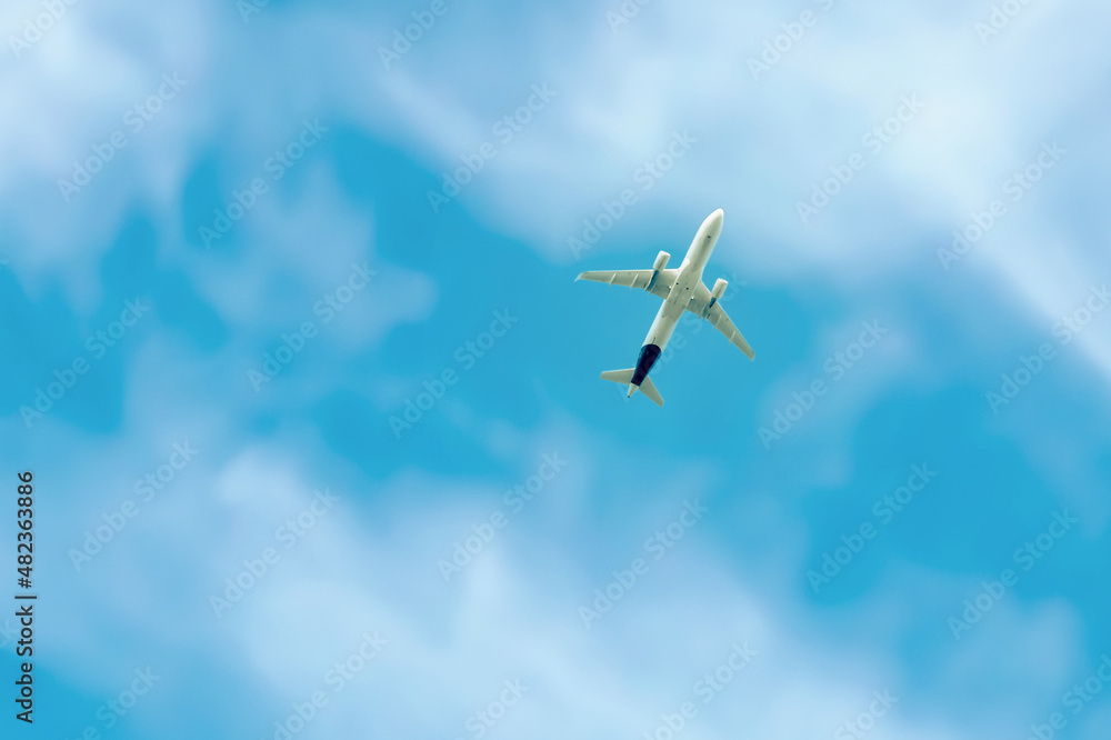 Commercial airplane flying against blue cloudscape sky. Jet plane in ...