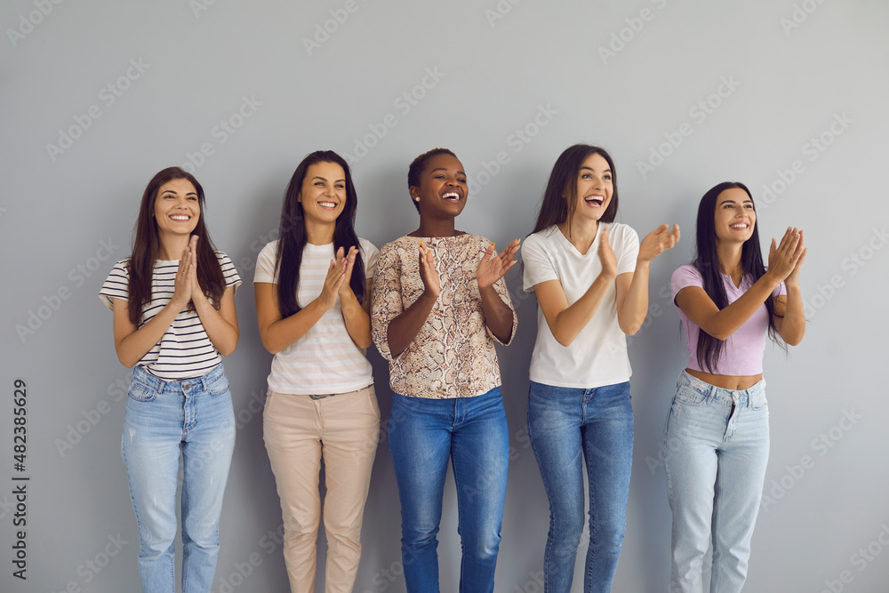 Happy multiethnic female audience giving round of applause. Group of ...