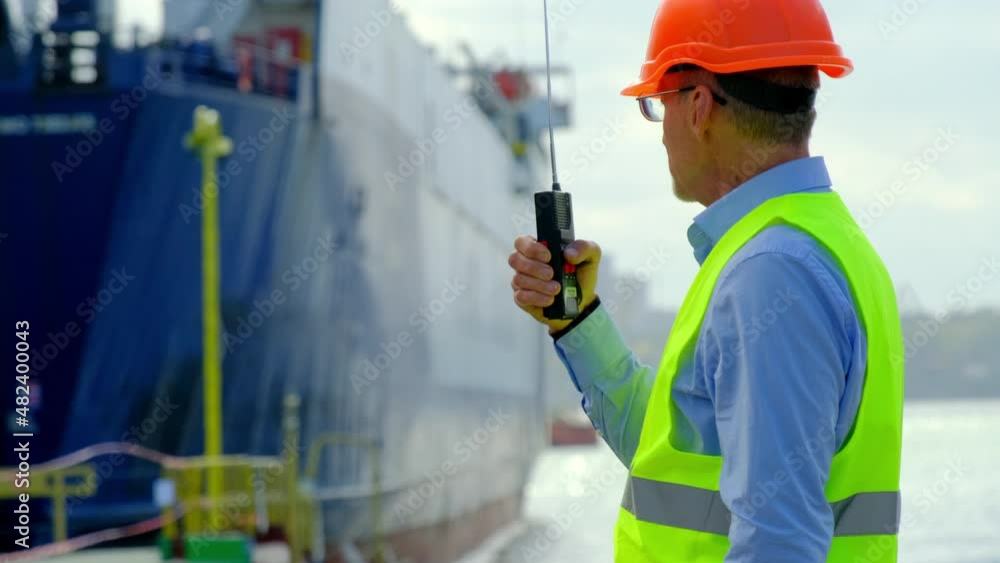 Port sea ship marine technology. Grey haired inspector communicates ...