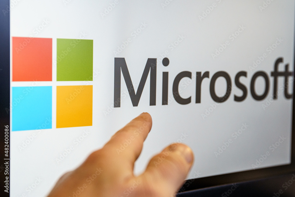 Microsoft logo on screen. Microsoft Corporation is an American ...