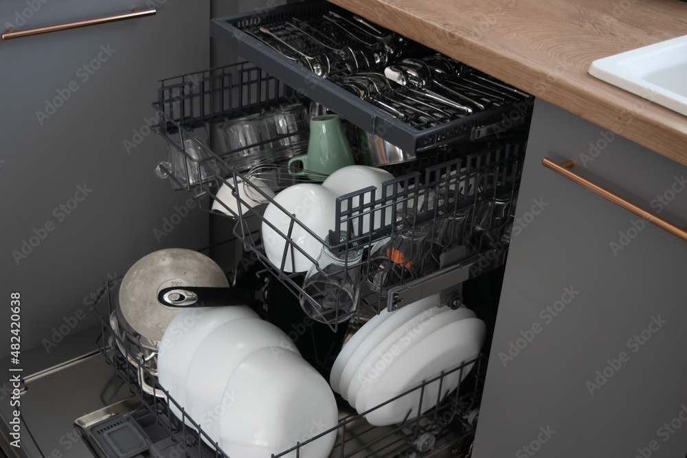 Dishwasher close-up with washed dishes, easy to use and save water, eco ...