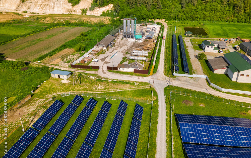 Aerial view of electrical power plant with rows of solar photovoltaic ...