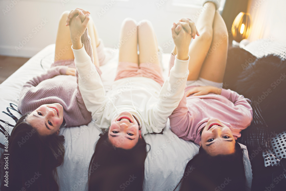 Three excited teenager girls having fun together enjoying laze leisure ...