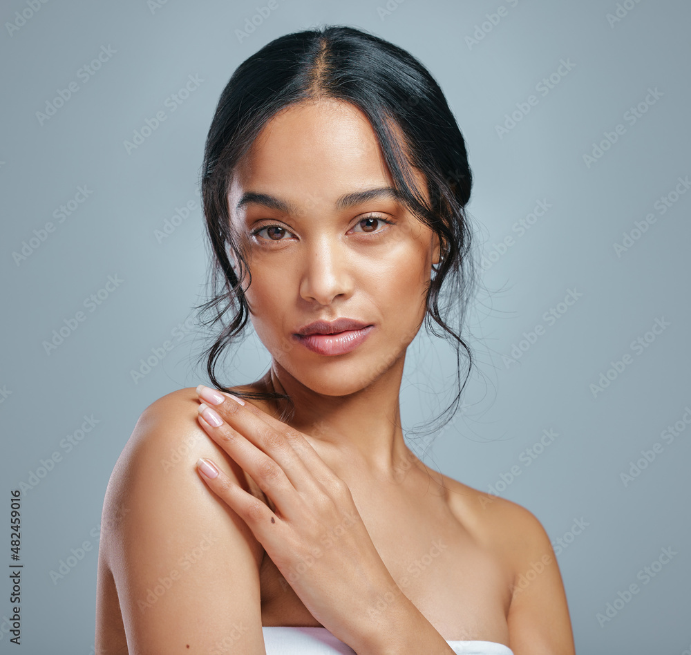 What a stunner. Studio portrait of an attractive young woman posing against a grey background ...