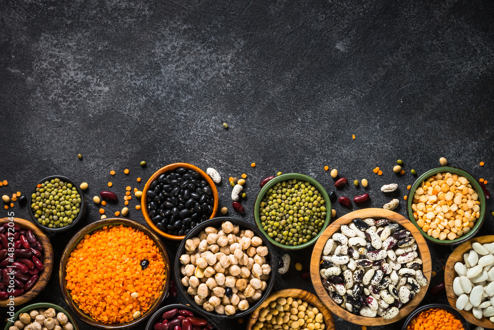Legumes, lentils, chikpea and beans assortment in different bowls on ...
