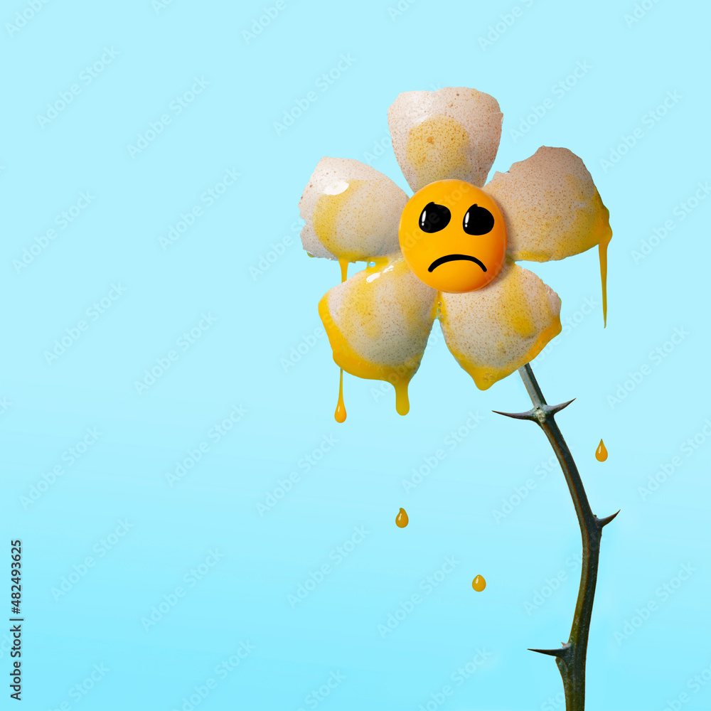 Unhappiness concept. Egg flower on a blue background. Crying with a sad ...