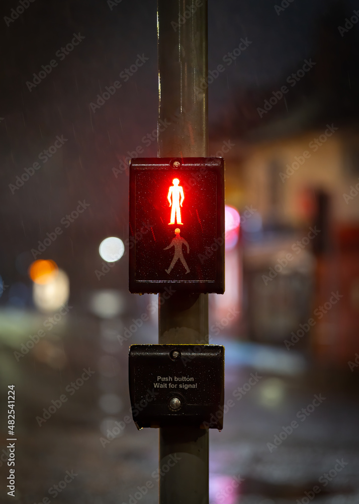 Red man stop sign illuminated at night on traffic light zebra crossing ...
