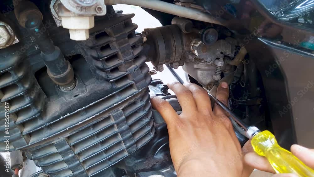 two wheeler motorbike maintenance at day from flat angle in details ...
