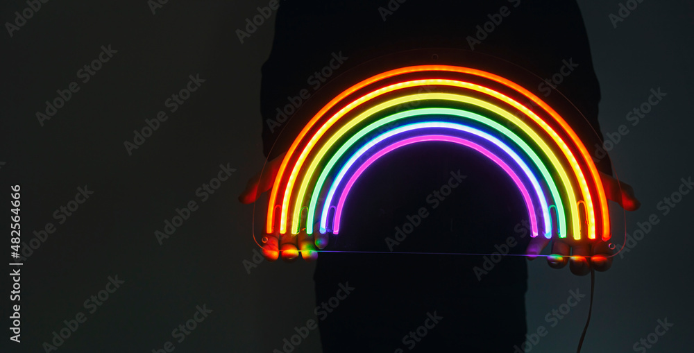 Girl holds neon led rainbow in hands in the night Stock Photo | Adobe Stock