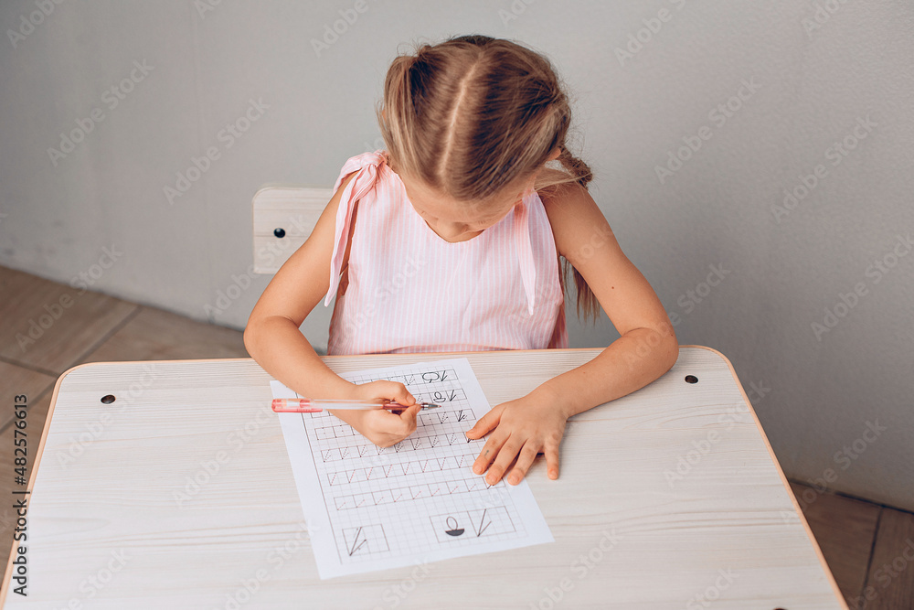 Top view of an adorable lovely young child drawing numbers on copy ...