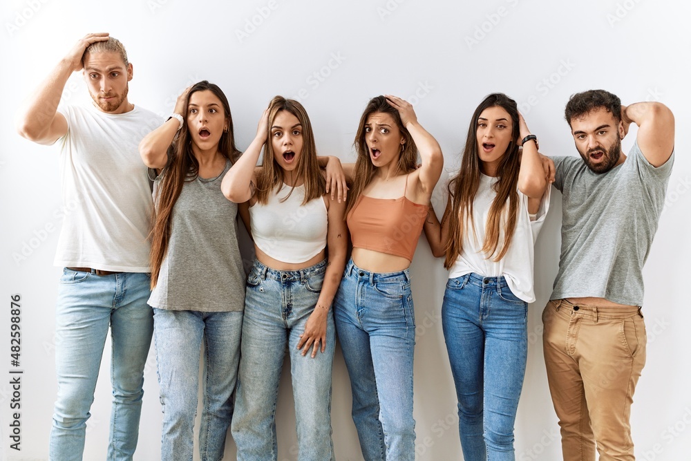 Group of young friends standing together over isolated background crazy ...
