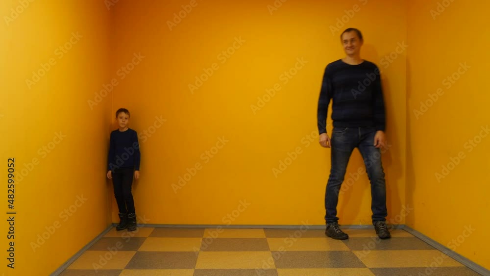 Optical Illusion with People Growth. Ames room. Father and Son in ...