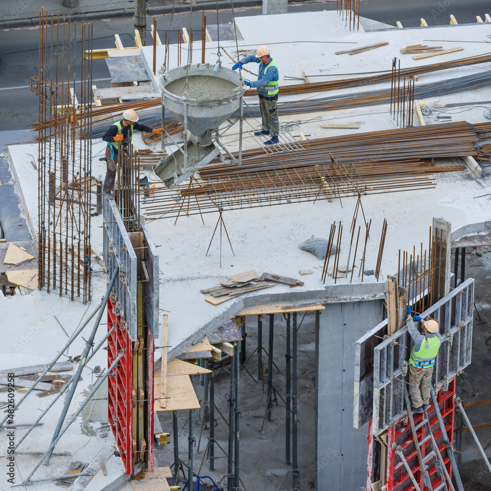 Building construction site work against blue sky.Hydraulic luffing jib ...