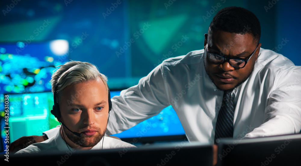 Aircraft flight control officer monitors the approach of aircraft from ...