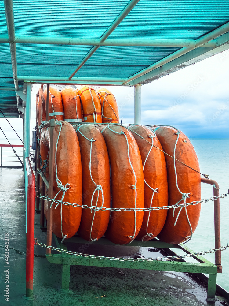 Orange inflatable lifeboats on ferry deck for emergencies and maritime ...