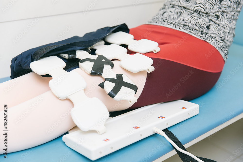Woman in clinic at the treatment of pressure therapy procedure for legs ...