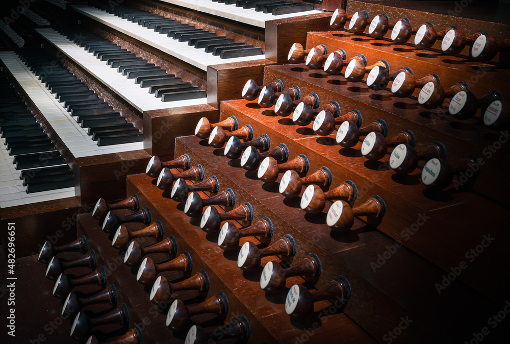 Keyboards and stop knobs of the console of the pipe organ Stock Photo ...