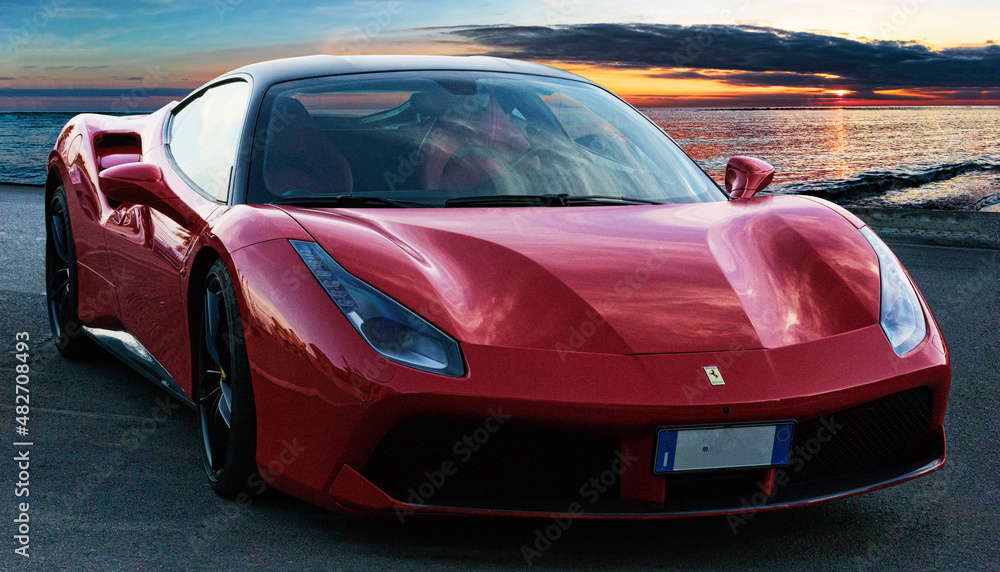 Luxury model sports car Ferrari 488 GTB located in scenic sunset ...