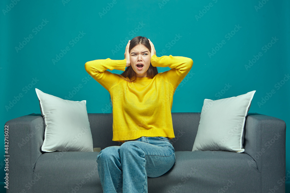 Annoyed stressed modern young girl cover ears avoid loud noise or feel ...