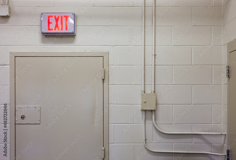 Exit sign in industrial interior Stock Photo | Adobe Stock