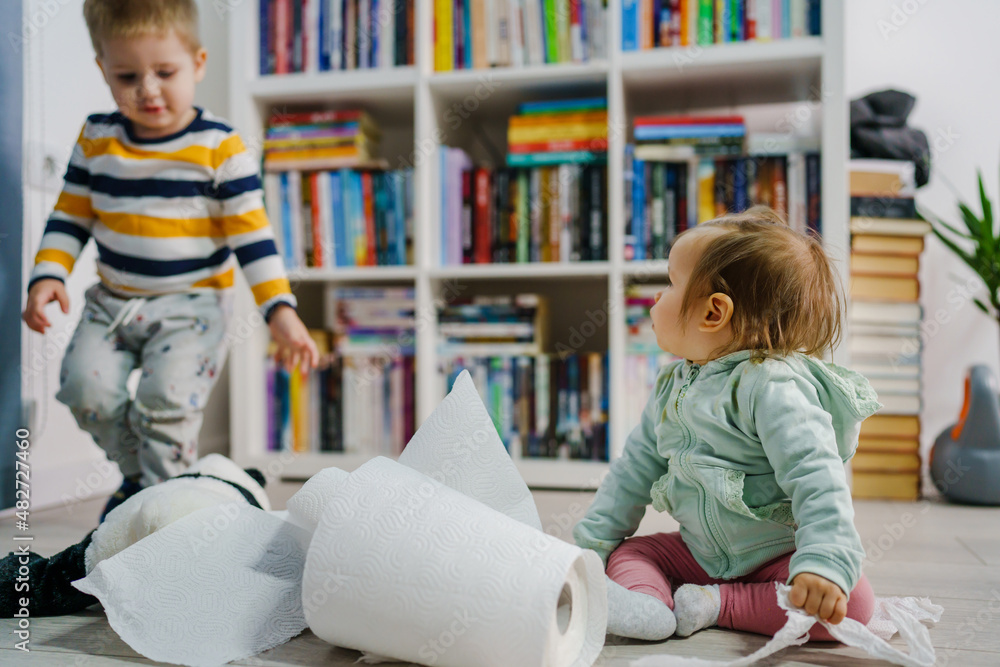 Brother and sister playing at home small caucasian baby girl and boy ...
