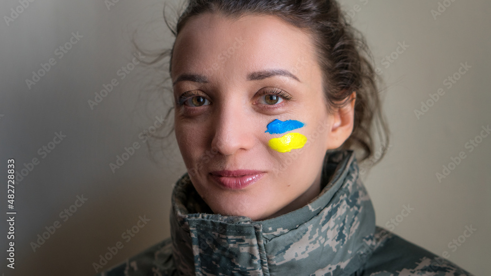 Indoor portrait of young girl with blue and yellow ukrainian flag on ...