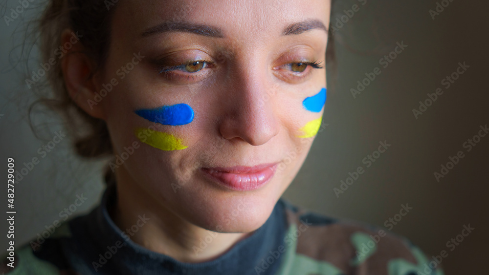 Indoor portrait of young girl with blue and yellow ukrainian flag on ...