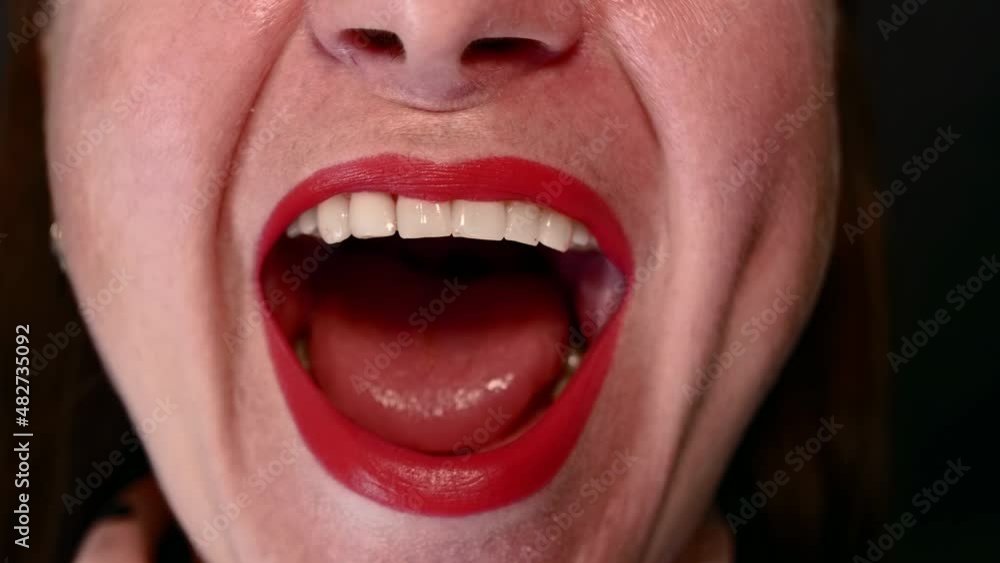 Close-up of the face of a caucasian woman with lips painted with red ...