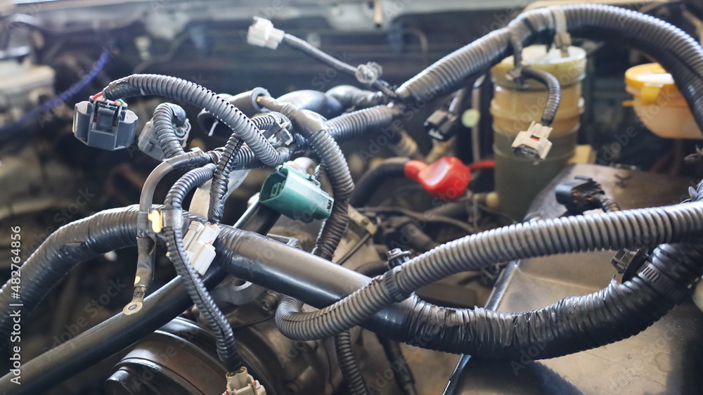 Messy car wiring in the garage. Car repair and wiring in old car engine ...