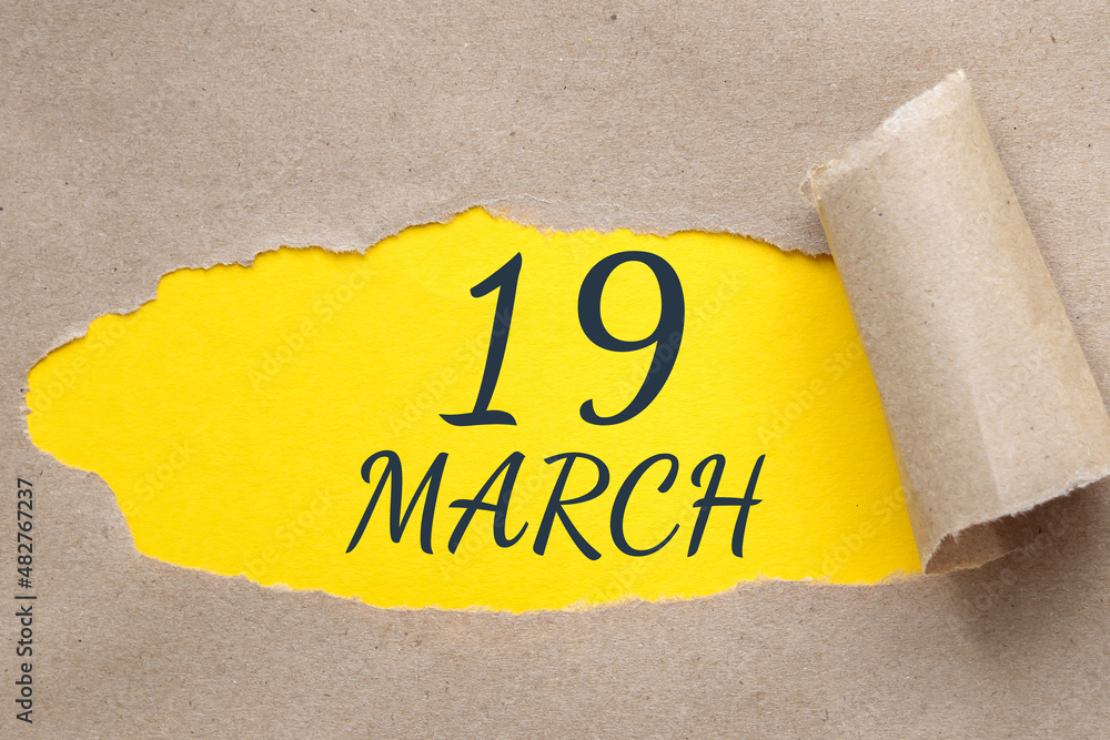 march 19. 19th day of the month, calendar date. Hole in paper with ...