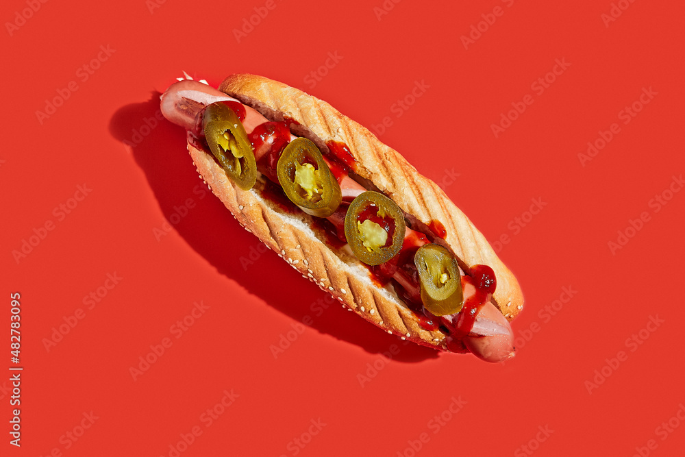 American hot dog with jalopeno on red background minimal style. Fast ...