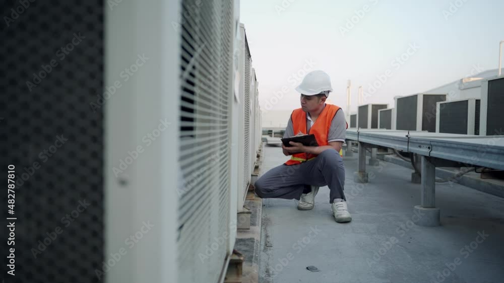 Utility engineer sitting near compressor recheck refrigeration system ...